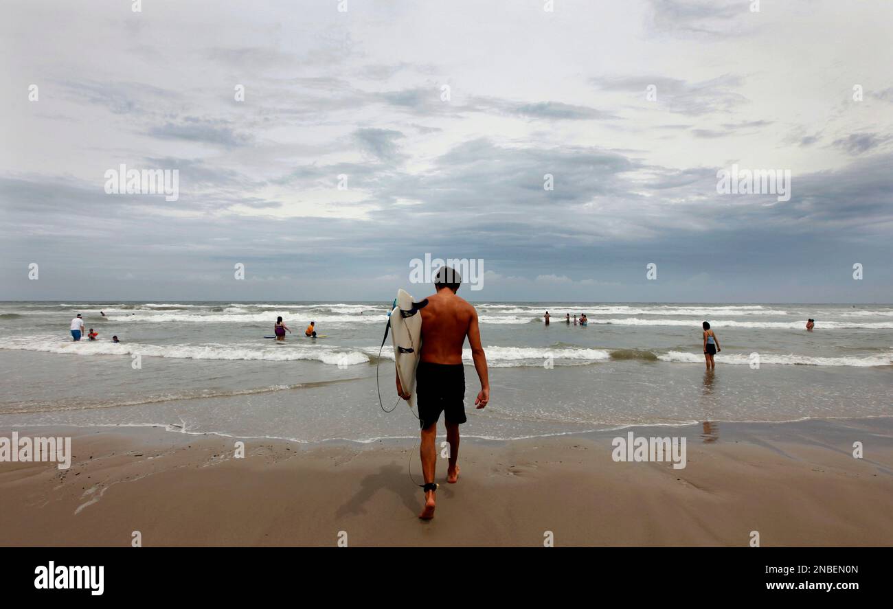 Collin Roche walks out into the Gulf of Mexico to surf as Tropical ...