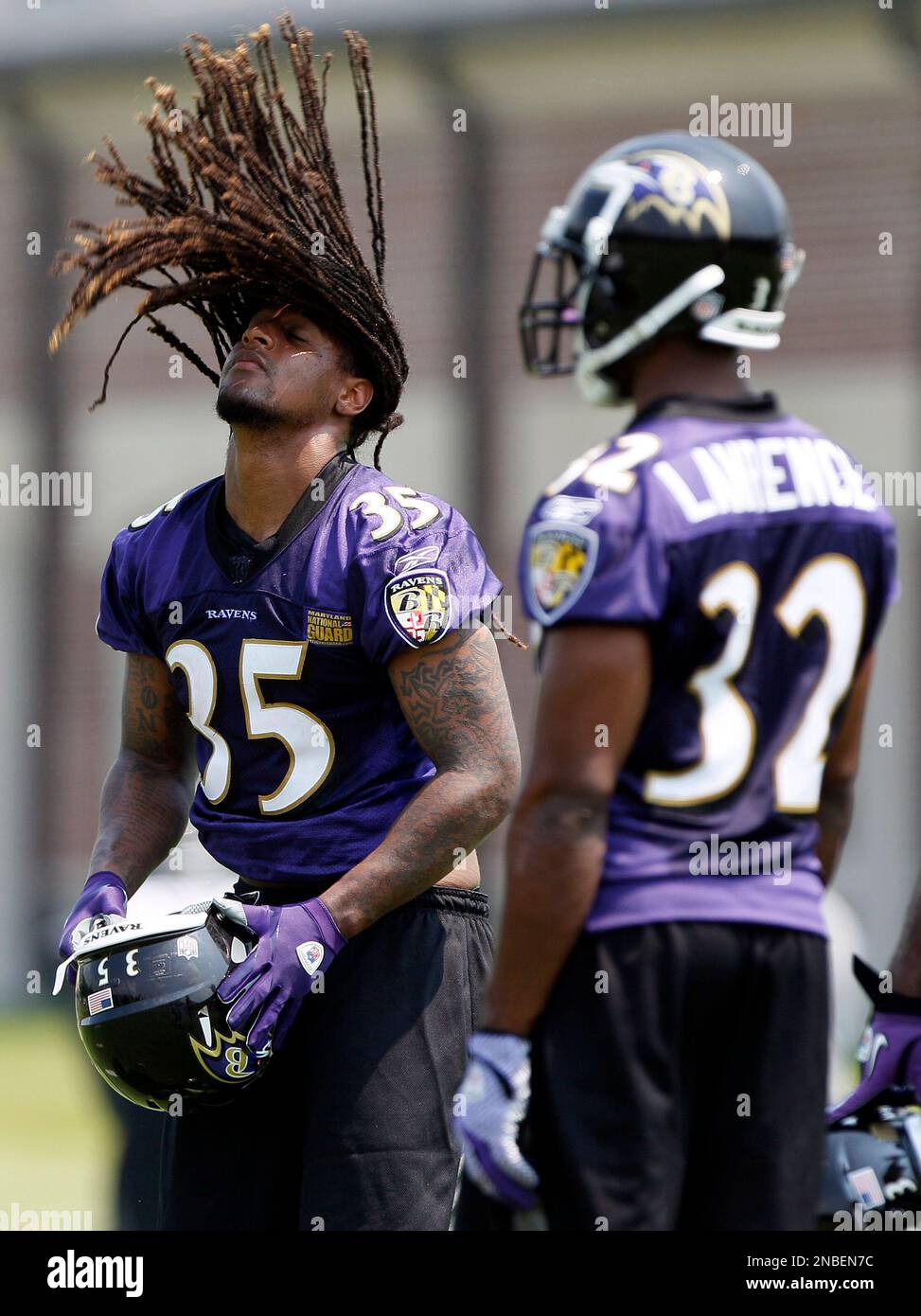 Baltimore Ravens running back Anthony Allen, left, flips his hair back ...