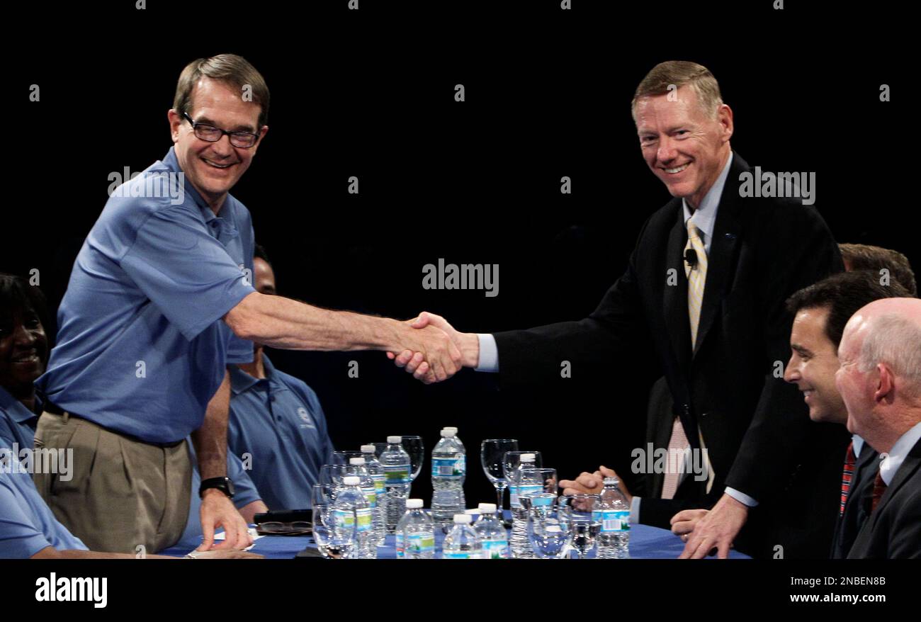 Ford Motor Company President and CEO Alan Mulally, right, shakes hands ...