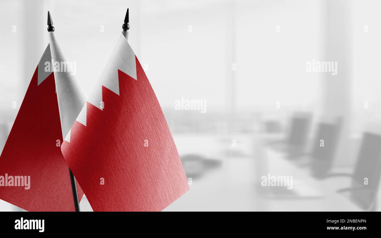 Small flags of the Bahrain on an abstract blurry background Stock Photo ...