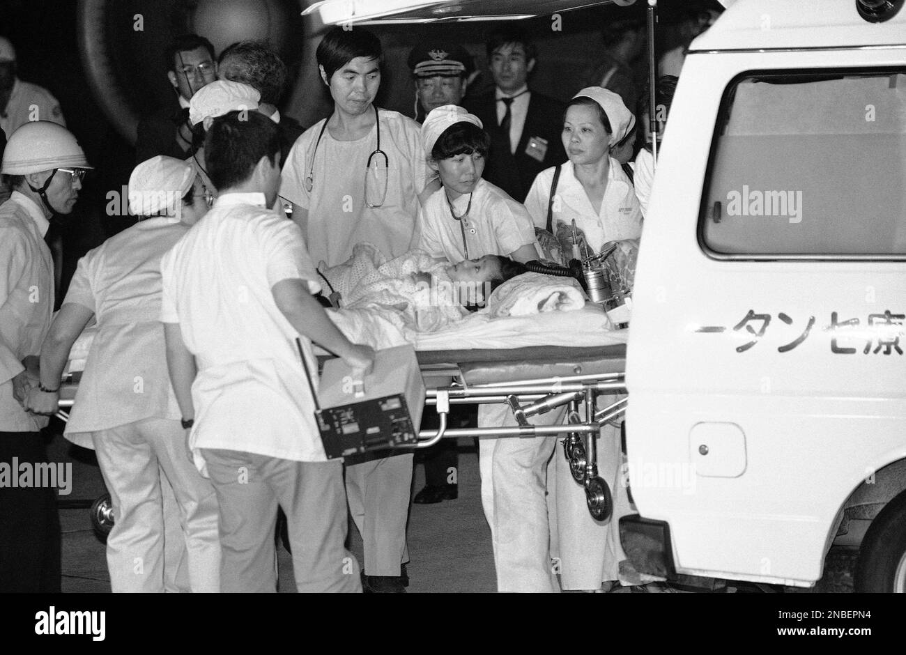 Five year old Vietnamese conjoined twin boys, Viet, not seen, and Duc, center, are carried on a ...