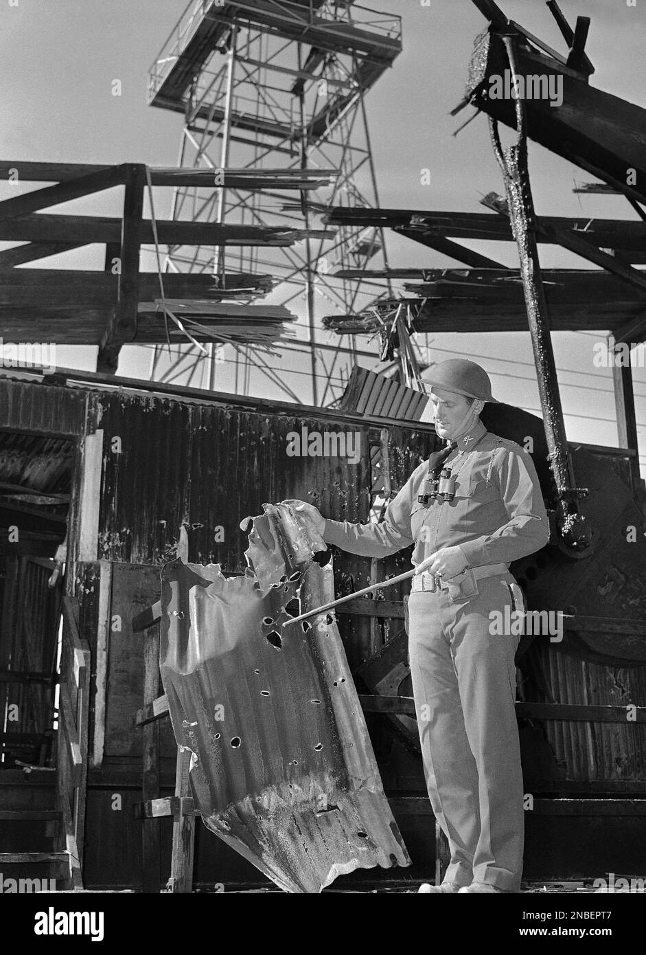 Capt. Barney Hagen points to damage done to side of an oil well pumping ...