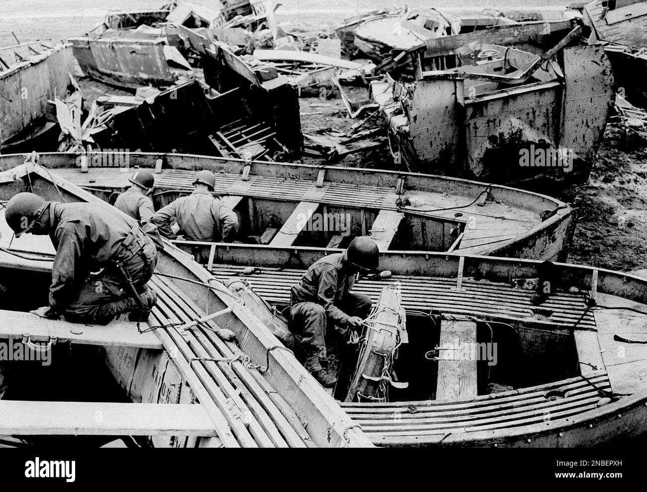 Repairmen of the U.S. Navy engineers at work at a landing craft ...