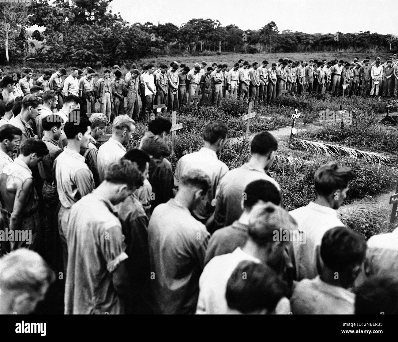 American troops, some in clothing made ragged by jungle fighting, stand ...