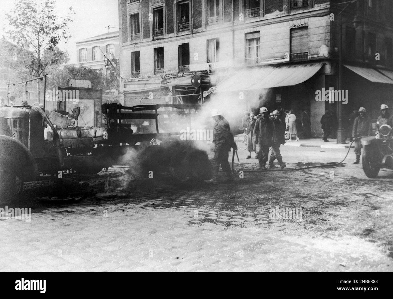 French firemen are shown putting out a blaze, which flared around a ...