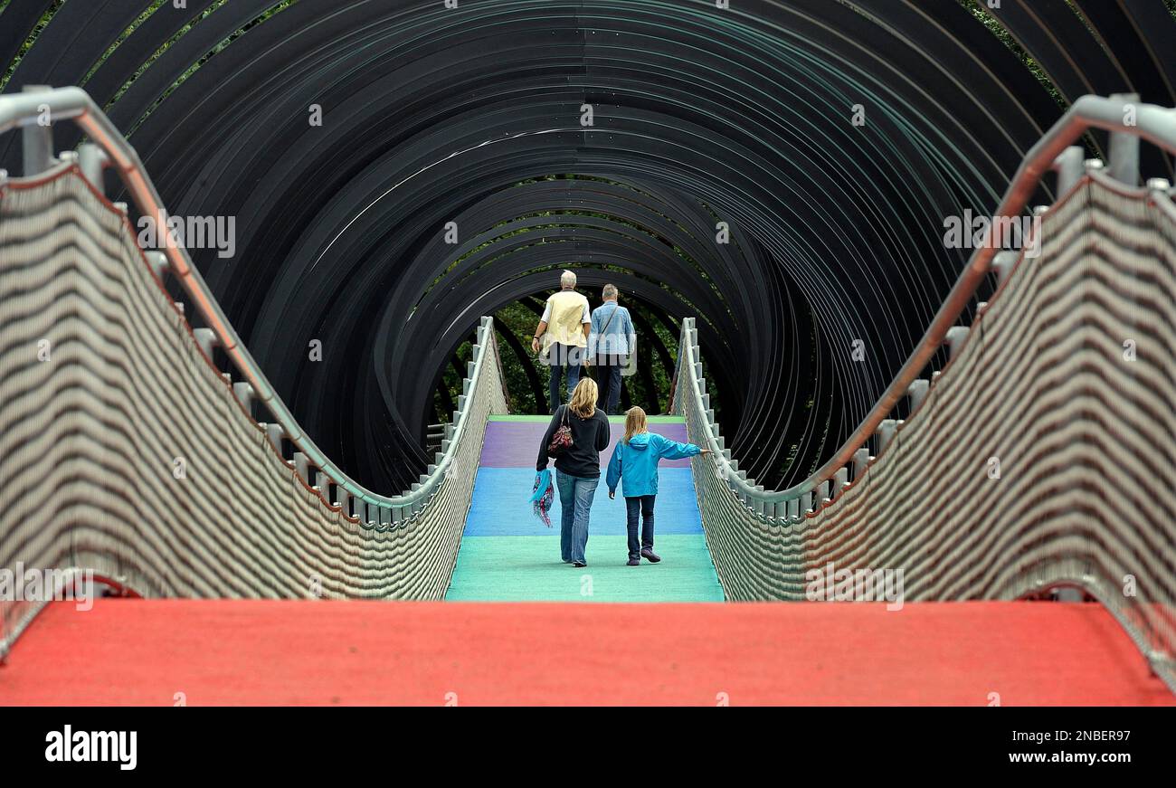 People walk on the 'Slinky springs to fame' bridge in Oberhausen ...