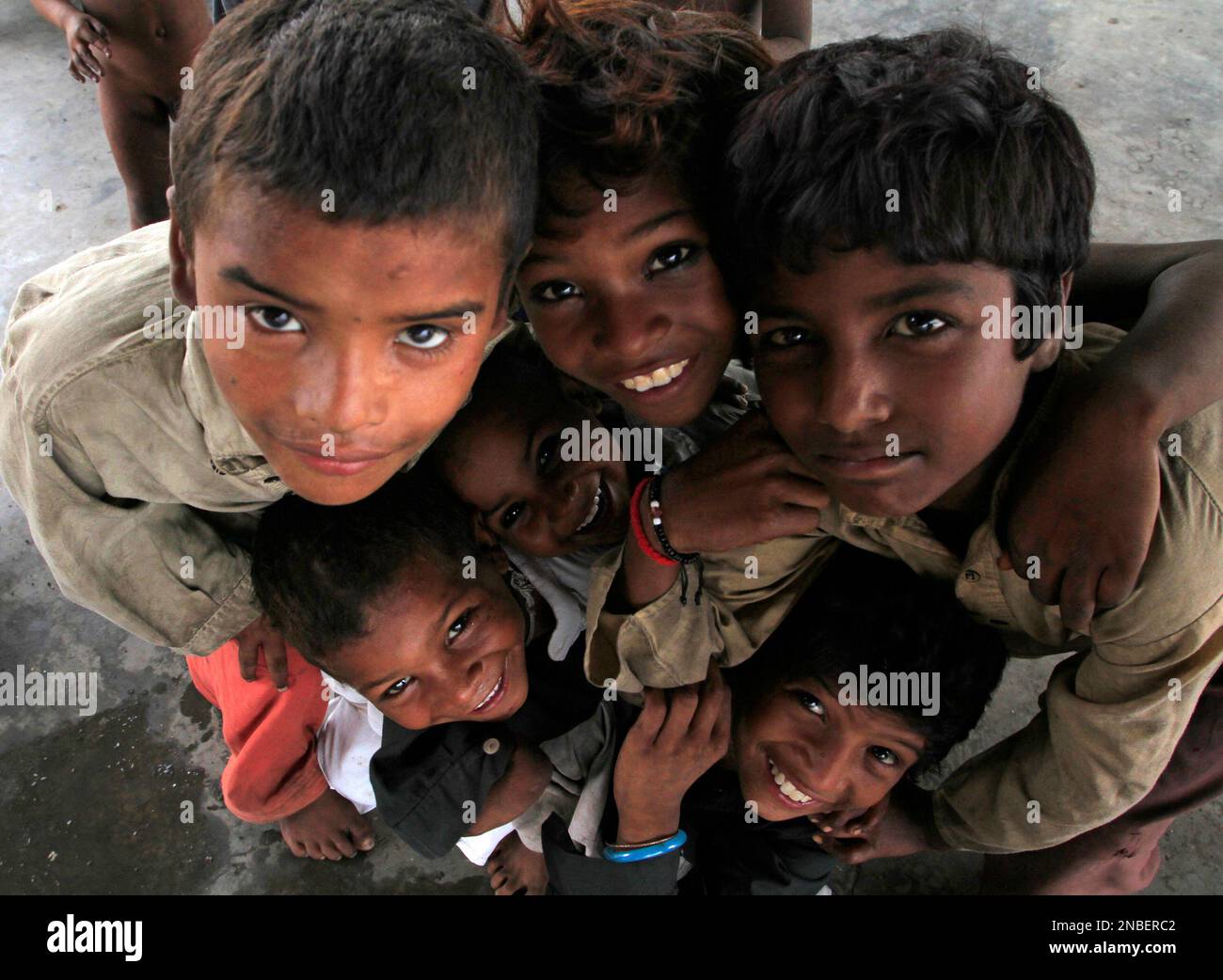 Pakistani homeless children who live under a bridge, pose in Karachi ...