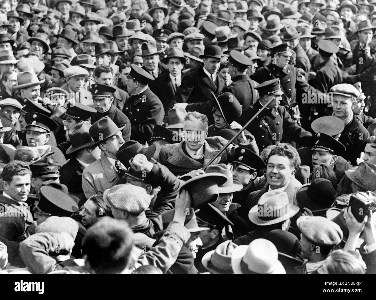 Actor Charlie Chaplin surrounded by fans in Vienna, Austria during his ...