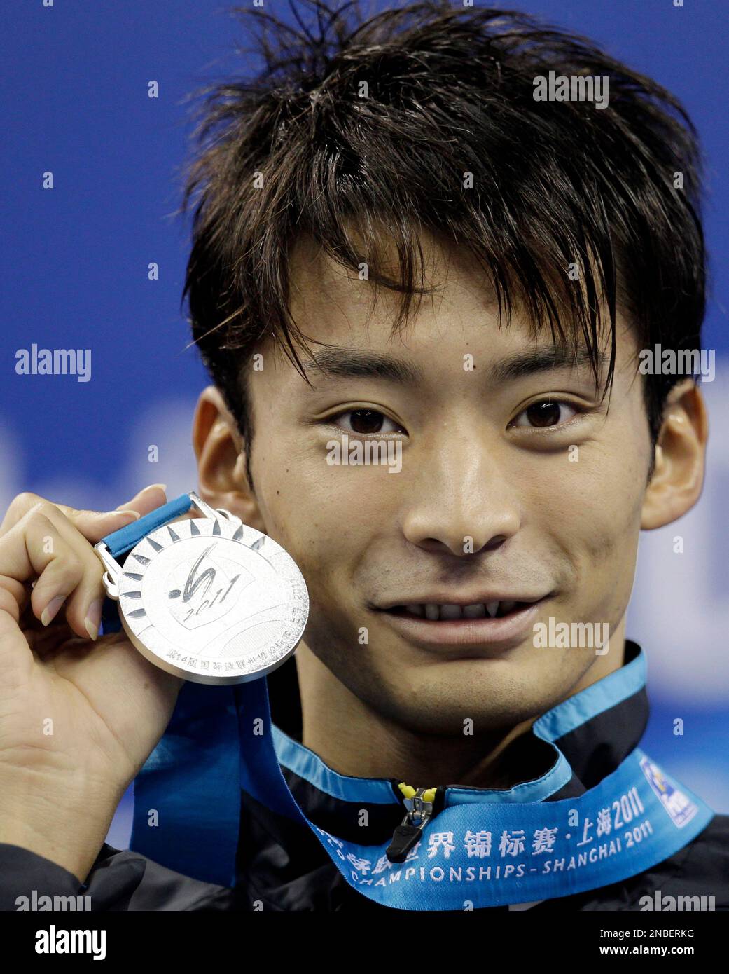 Japan's Ryosuke Irie shows the silver medal he won in the men's 200m ...