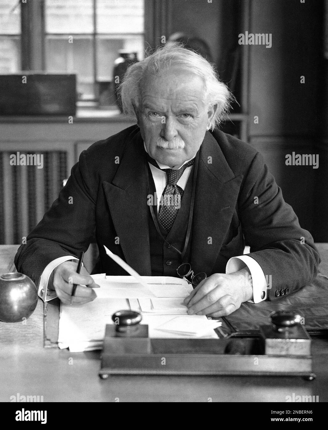David Lloyd George, Leader of the Liberal Party, at work at his desk in ...