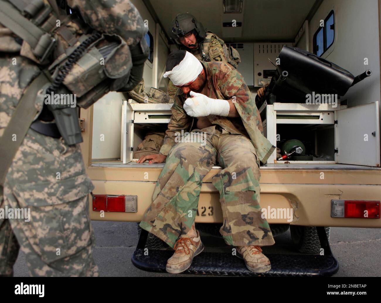 A wounded Afghan National Army soldier sits on an ambulance as U.S ...