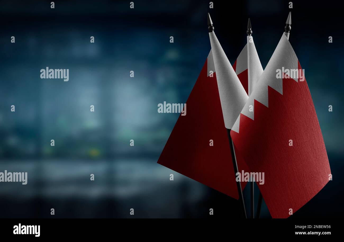 Small flags of the Bahrain on an abstract blurry background Stock Photo ...