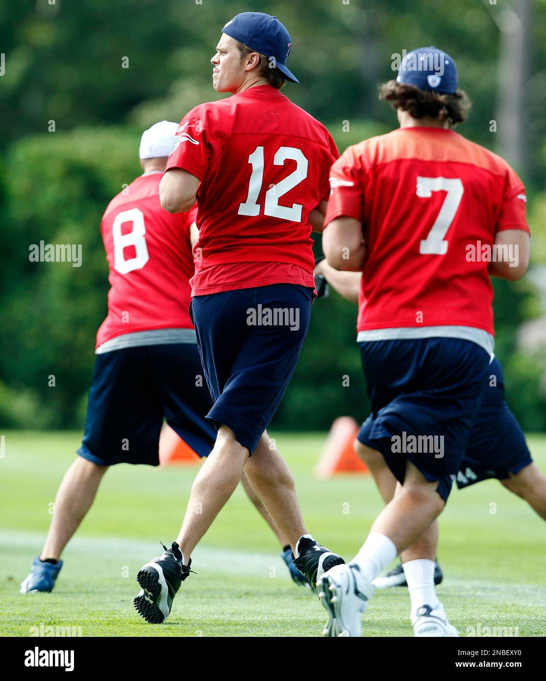 New England Patriots quarterback Tom Brady (12) fades back to throw ...