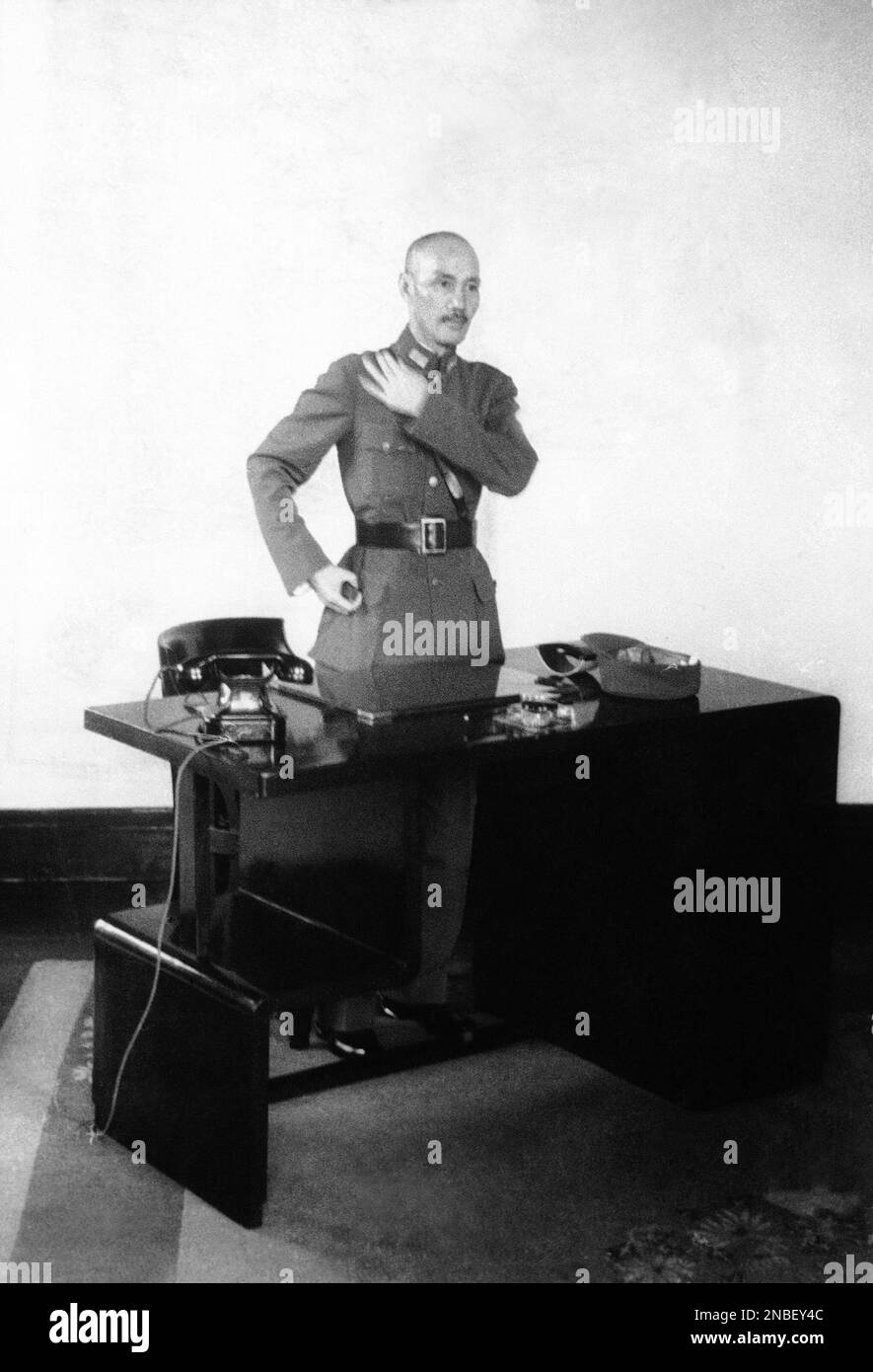 General Chiang Kai-Shek at his desk on Nov. 8, 1938, with his war map ...