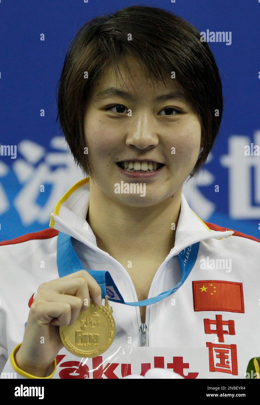 China's Jiao Liuyang shows the gold medal she won in the women's 200m Butterfly final at the ...