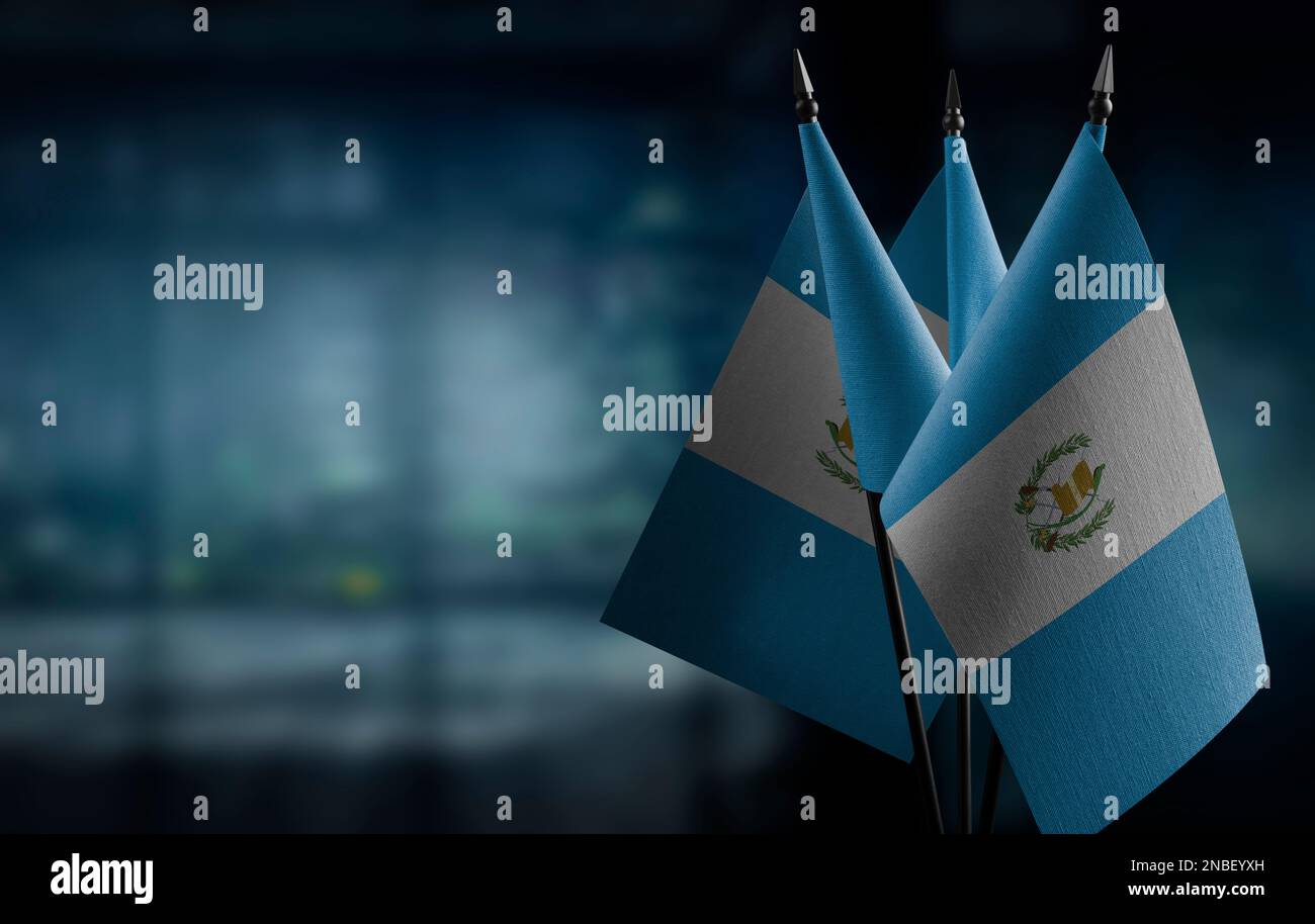 Small flags of the Guatemala on an abstract blurry background Stock ...