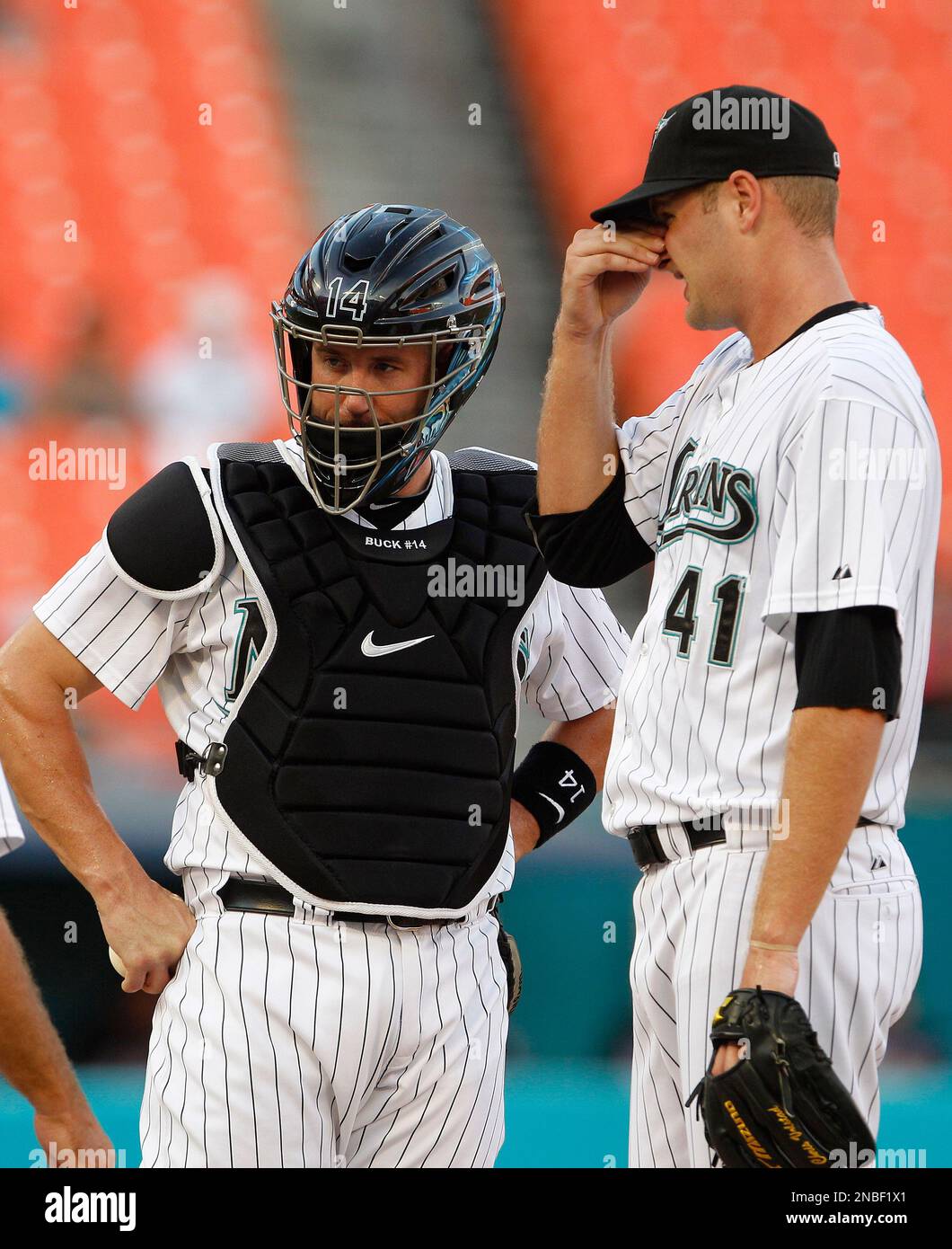 Florida Marlins catcher John Buck, left, stands on the mound with ...