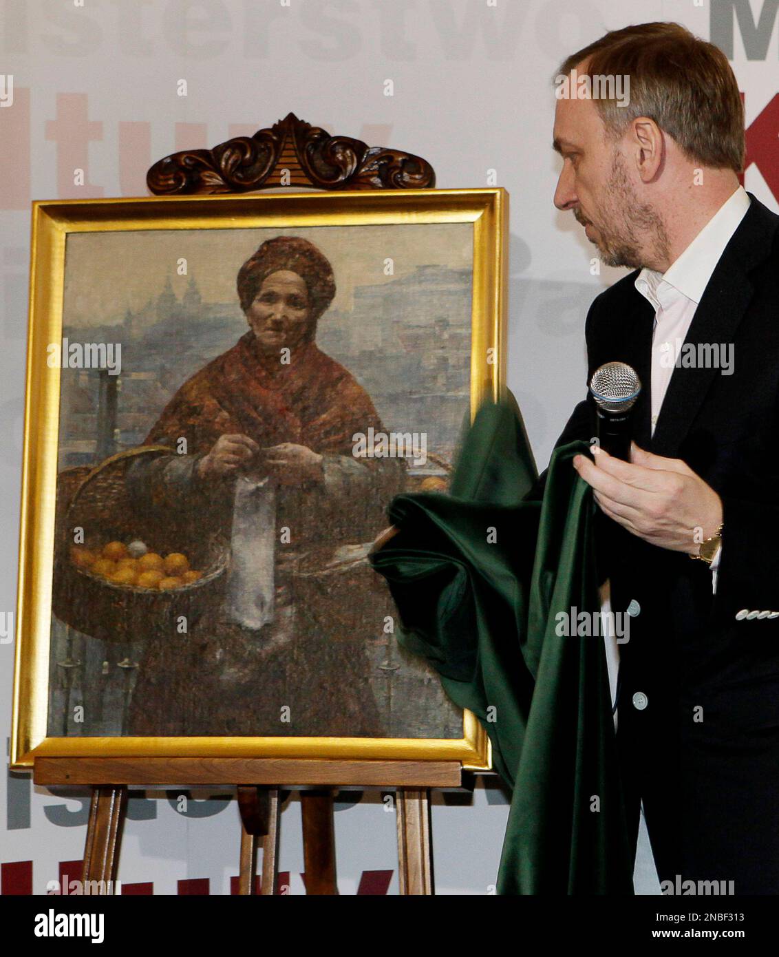 Poland's Culture Minister Bogdan Zdrojewski shows 19th century painting ...