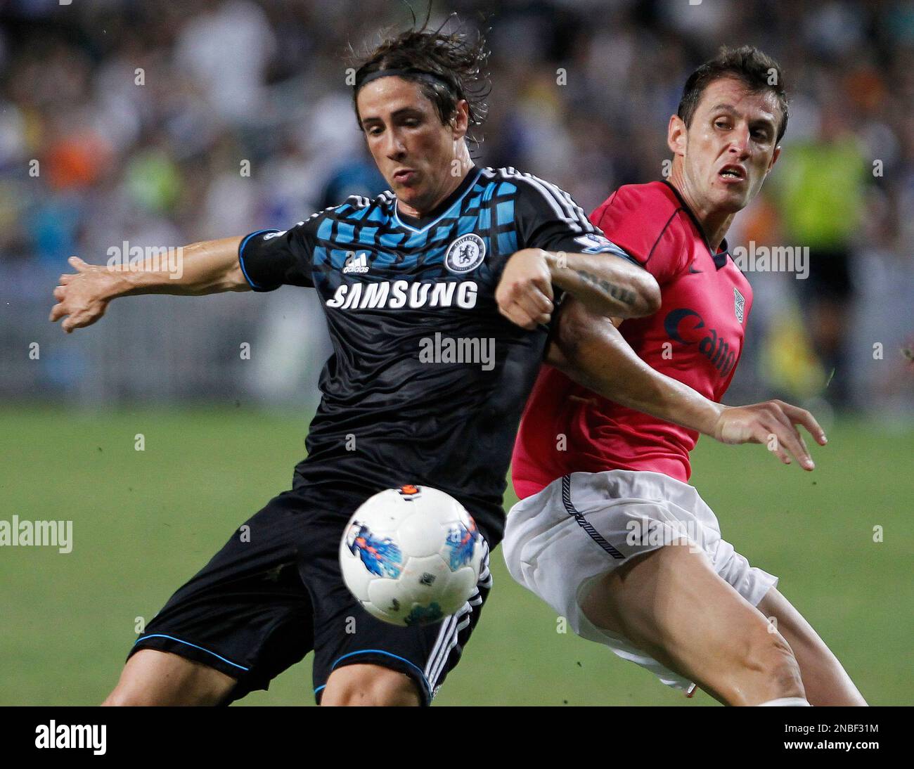 Chelsea's Fernando Torres, left, battles for the ball with Kitchee's ...