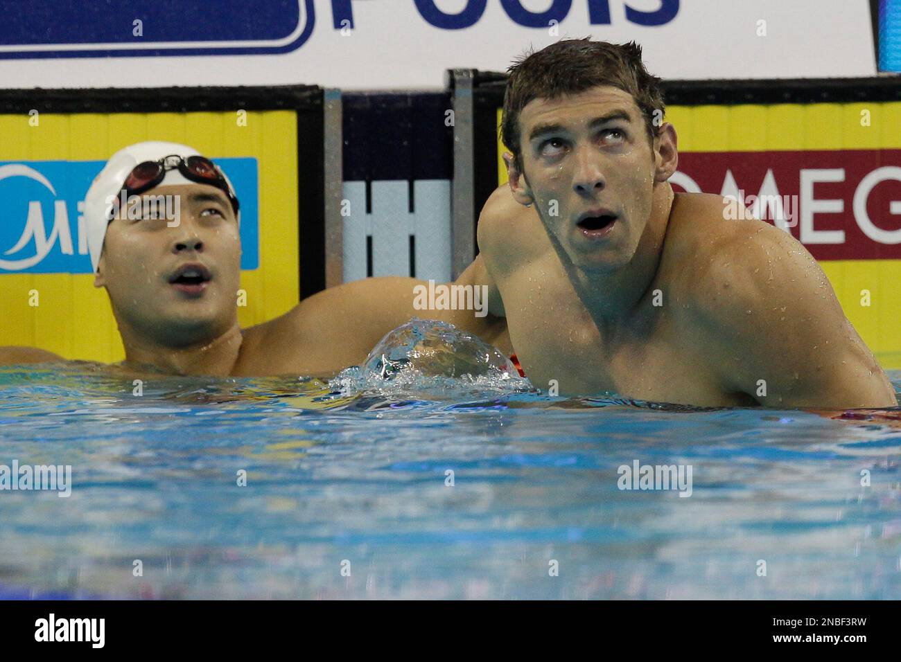 U.S. Michael Phelps, right, and China's Wu Peng look at the scoreboard ...