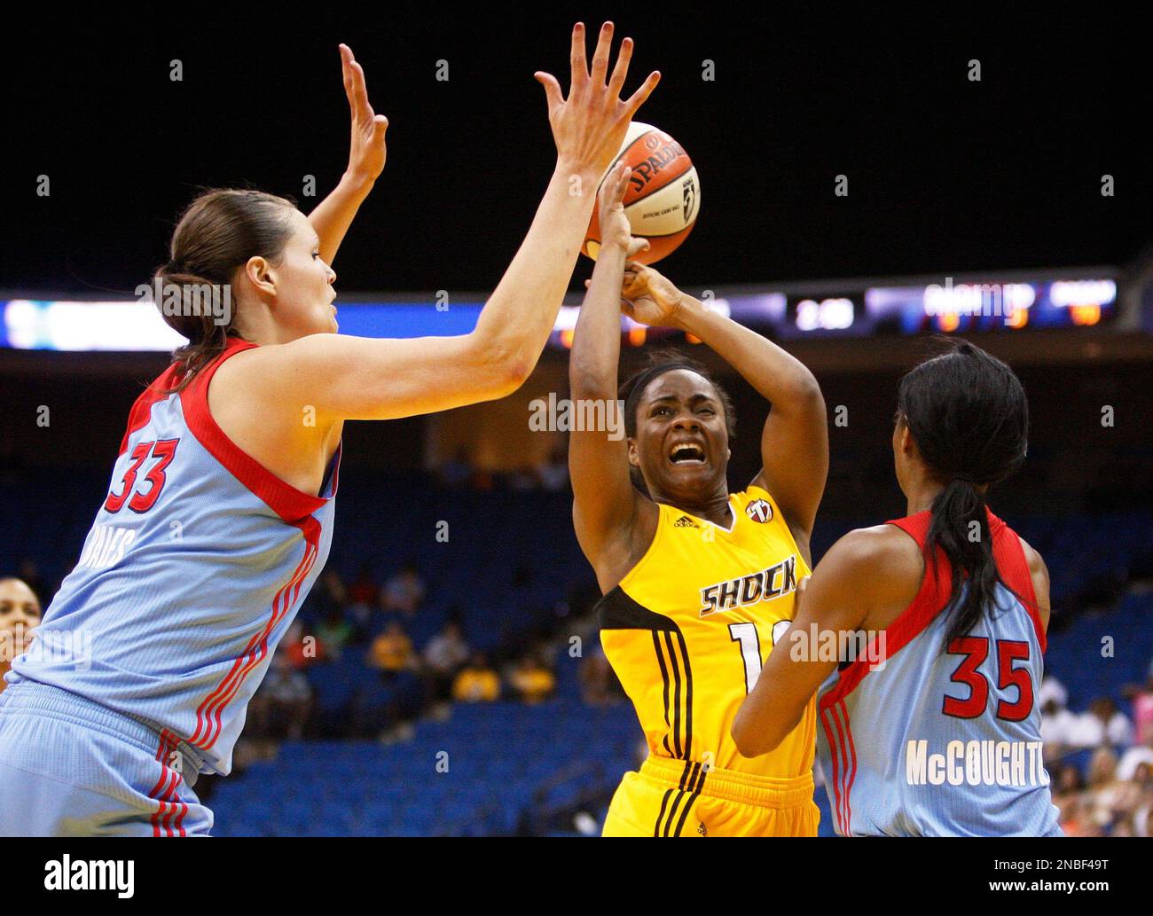 Tulsa Shock guard Ivory Latta, center, loses control of the ball ...