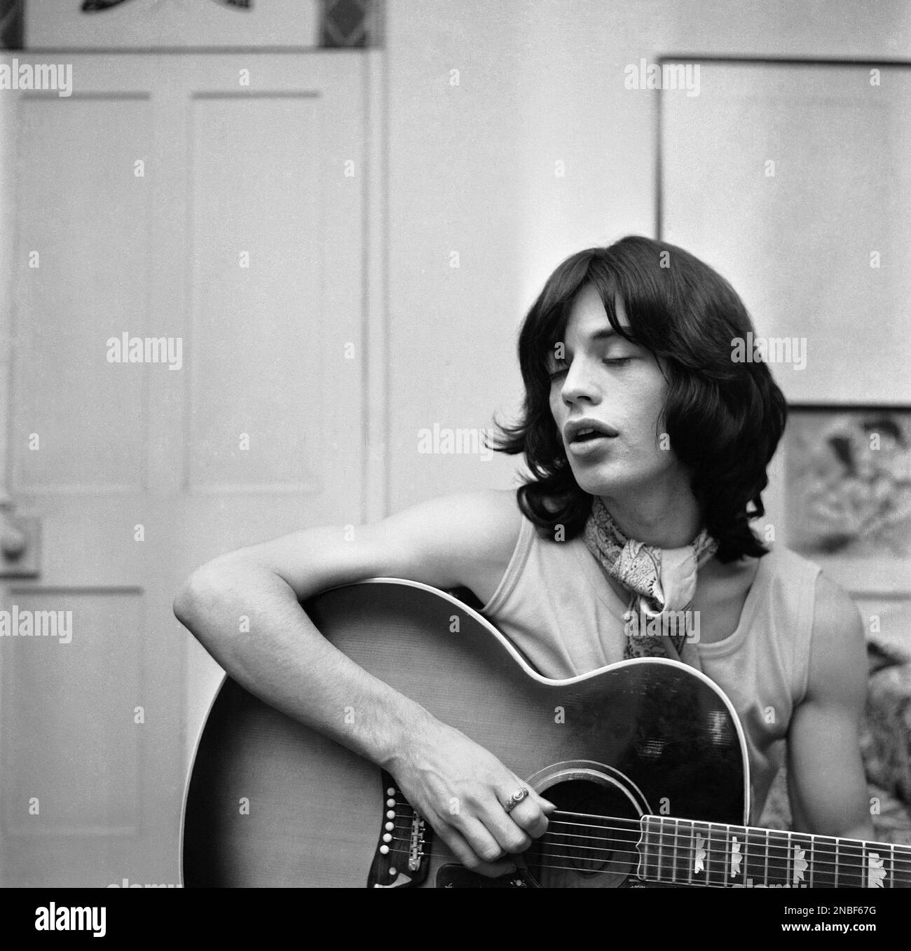 Rolling Stone Mick Jagger relaxes with a guitar in a London dressing ...