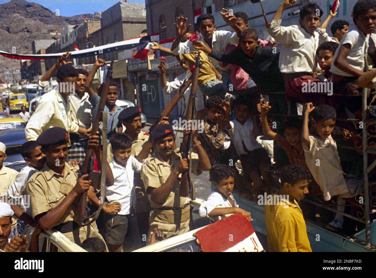 Armed police and Arab nationals celebrate in the Crater District of ...