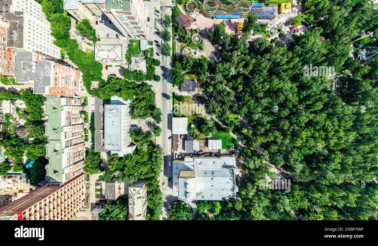 Aerial city view with crossroads and roads, houses, buildings, parks ...