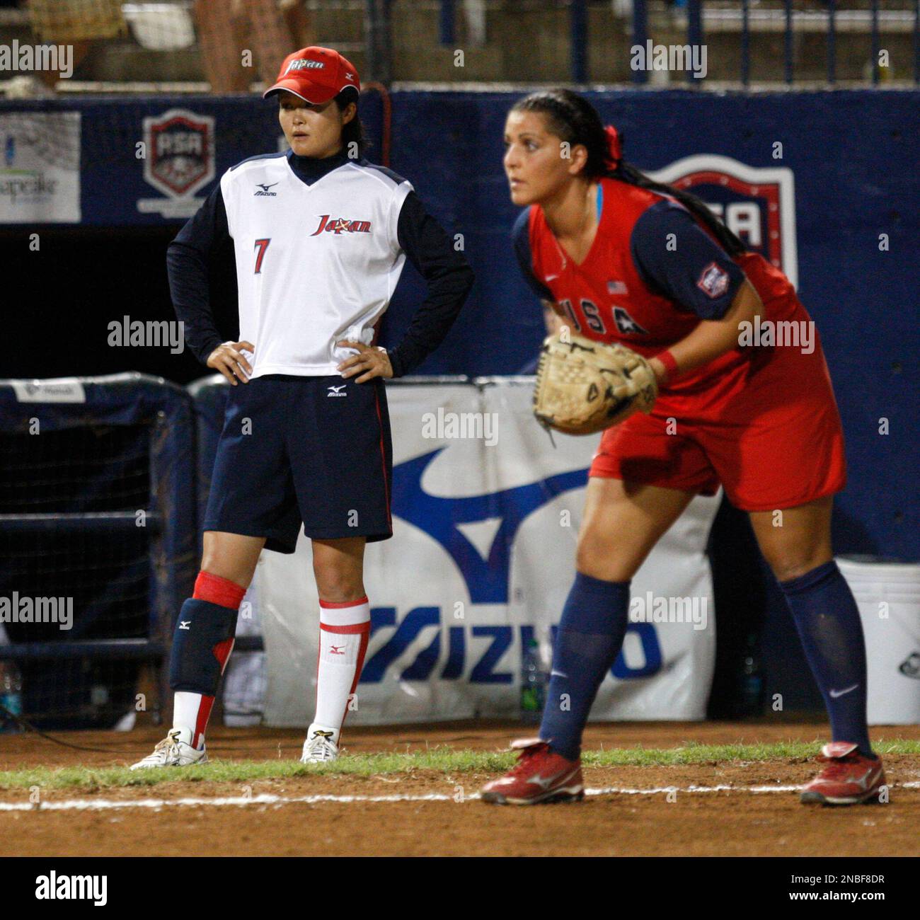 Japan's Yumi Iwabuchi, left, stands in the third base coach's box in ...