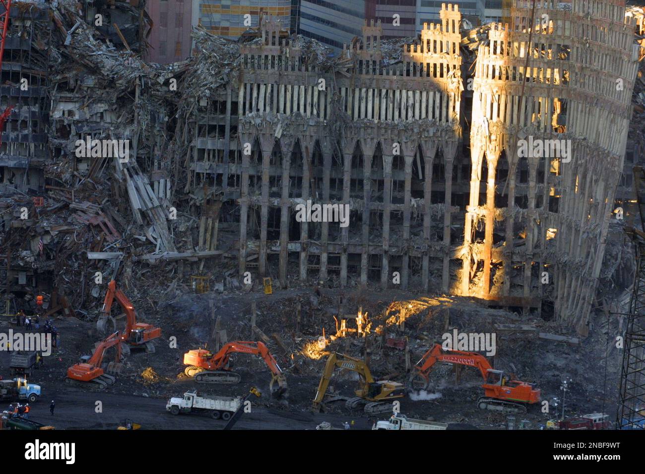 Workers clear debris at the site of the World Trade Center, destroyed ...