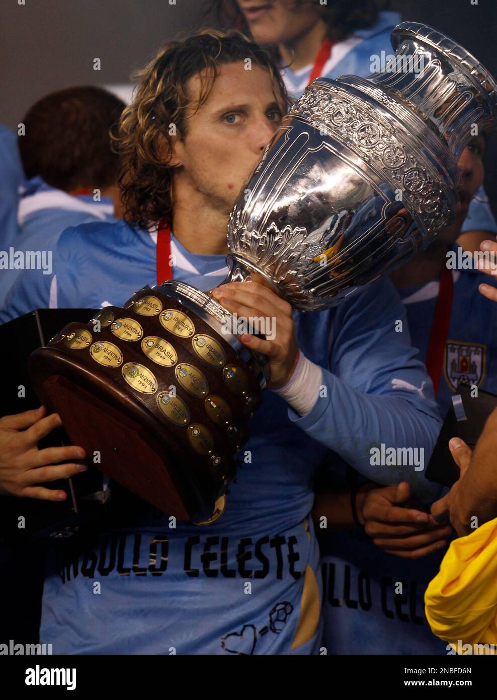 Uruguay's Diego Forlan holds the Copa America at the end of the final ...