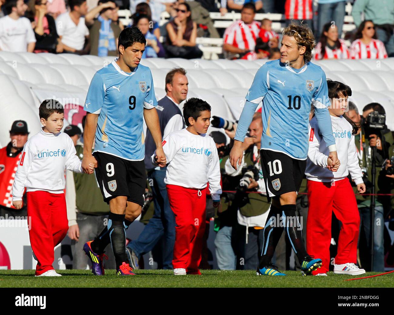 Uruguay's Luis Suarez, left, and Diego Forlan enter the pitch prior to ...