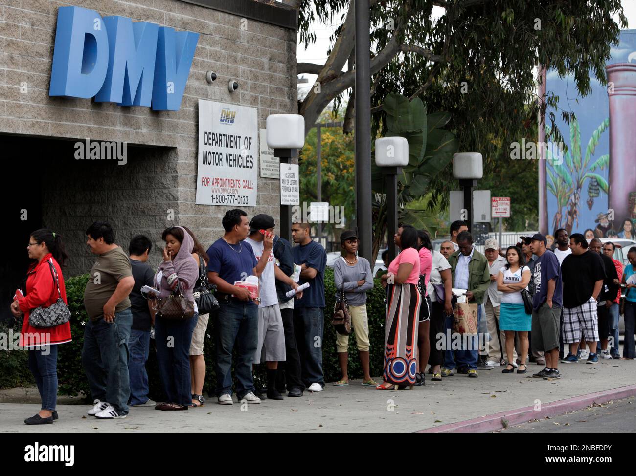 In this July 11, 2011 photo, people line up to apply for drivers ...