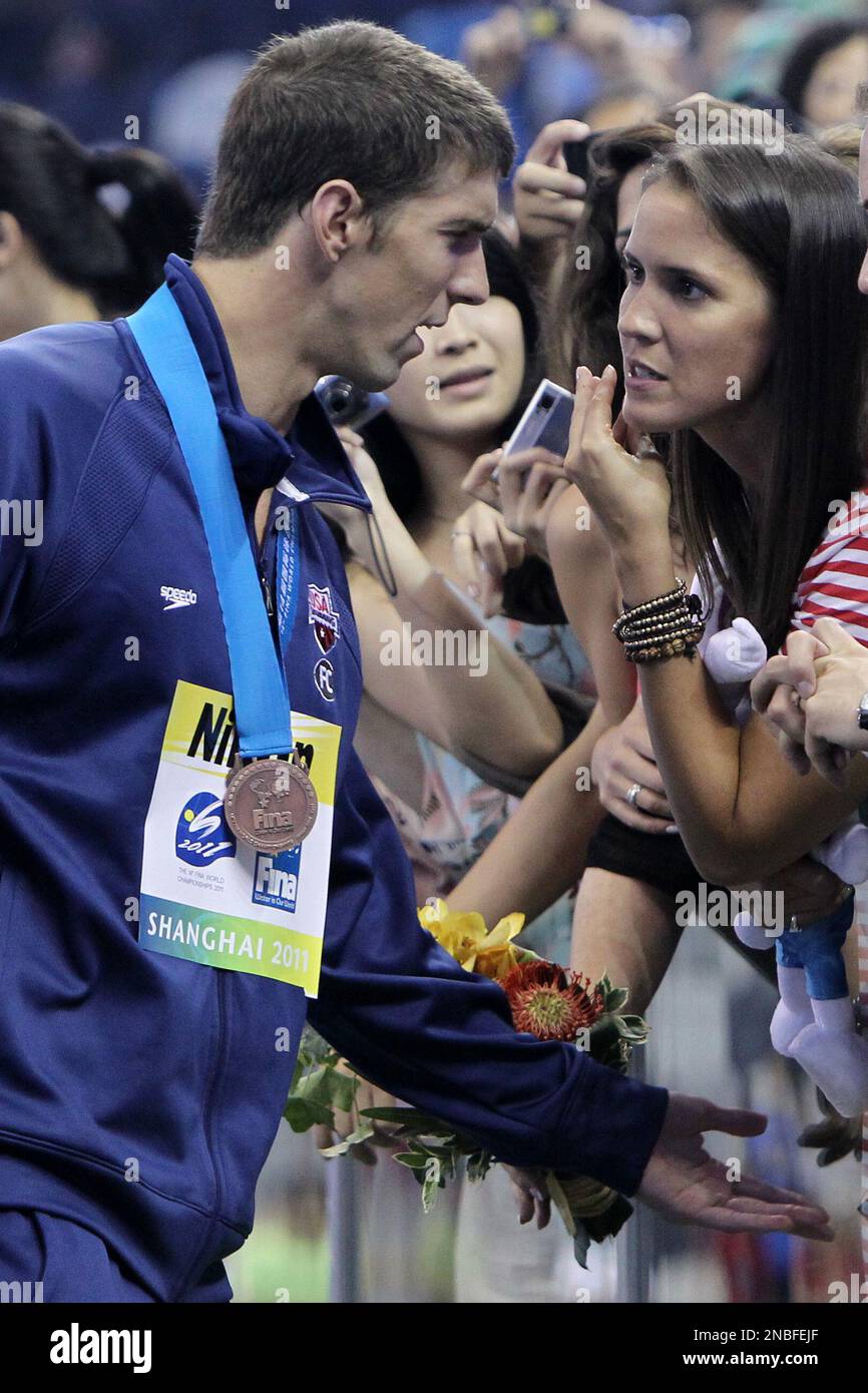 Michael Phelps of the U.S. chats with girlfriend Nicole Johnson after ...