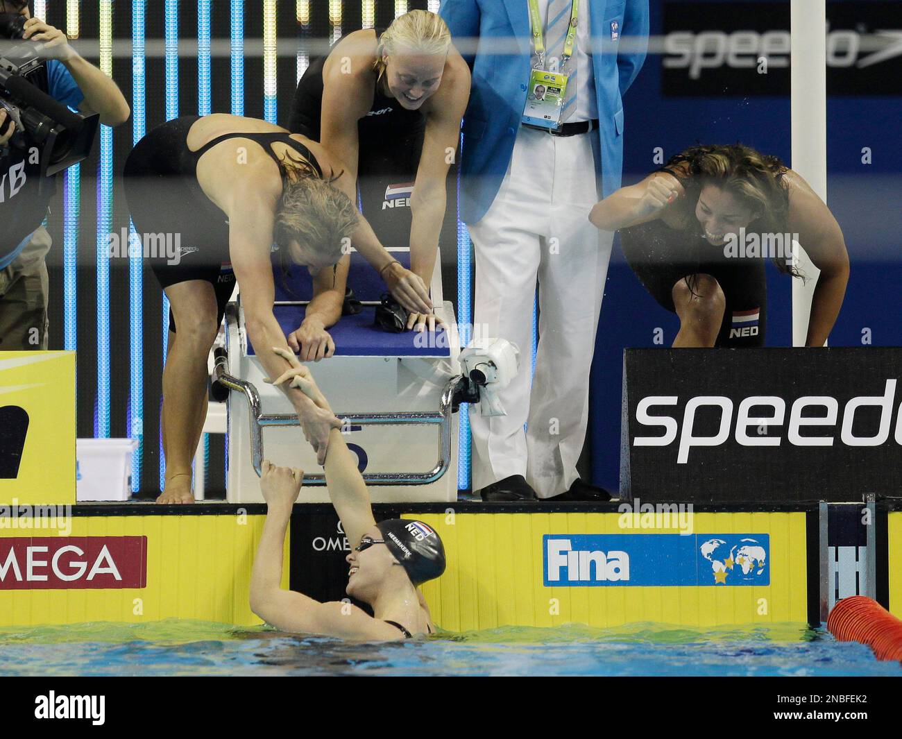 Dutch swimmer Femke Heemskerk, bottom, is congratulated by teammates ...