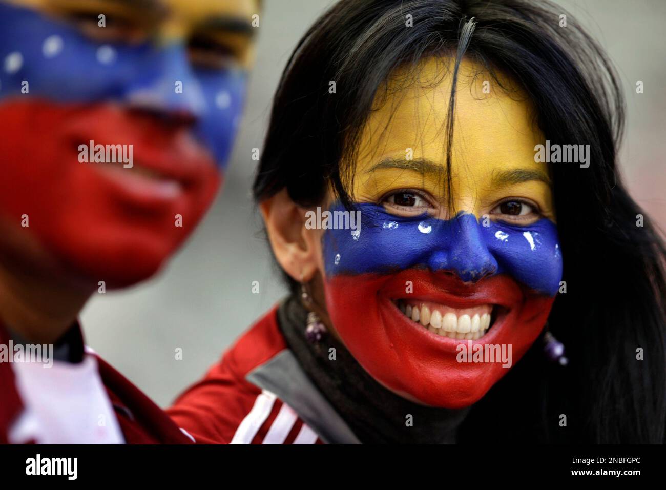 Venezuela's fans, their faces painted with the colors of the Venezuelan ...