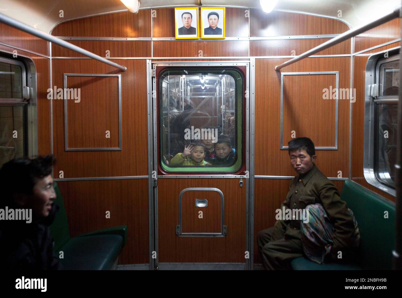 In this March 10, 2011 photo, children look through a subway car window ...