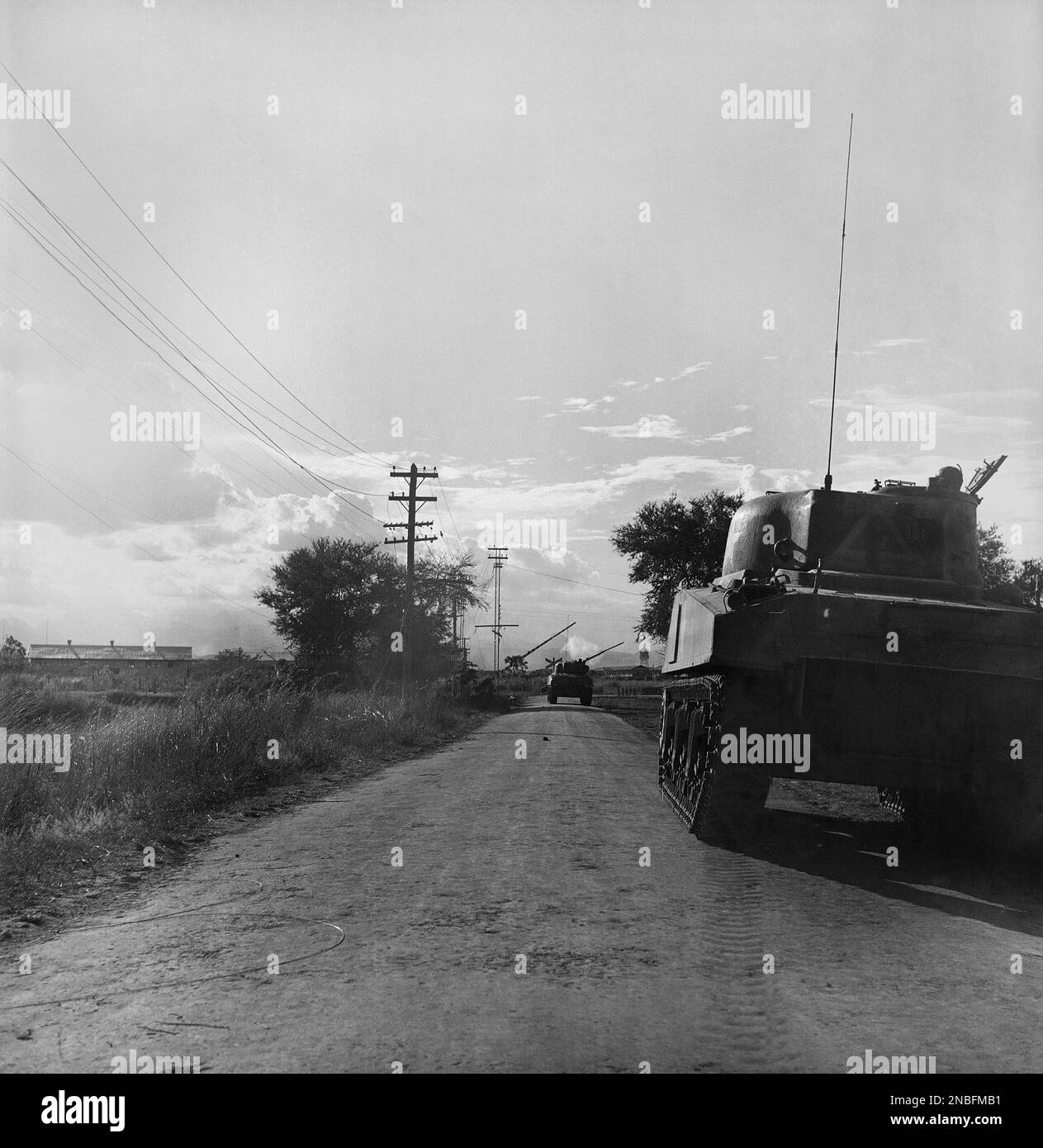 These General Sherman tanks are entering Fort Stotsenburg, Luzon ...