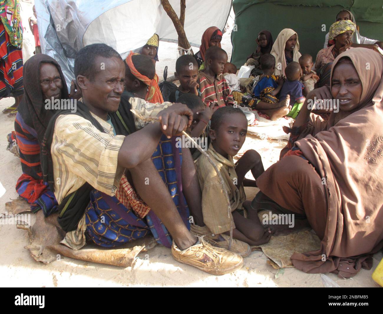 A Somali family from southern Somalia rest in their makeshift shelter ...