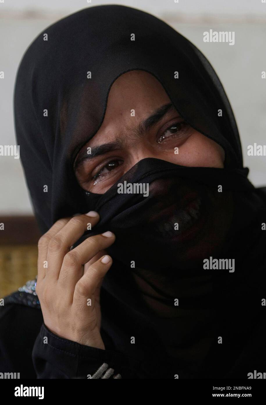 A Pakistani woman mourns the death of her brother who was shot dead by ...