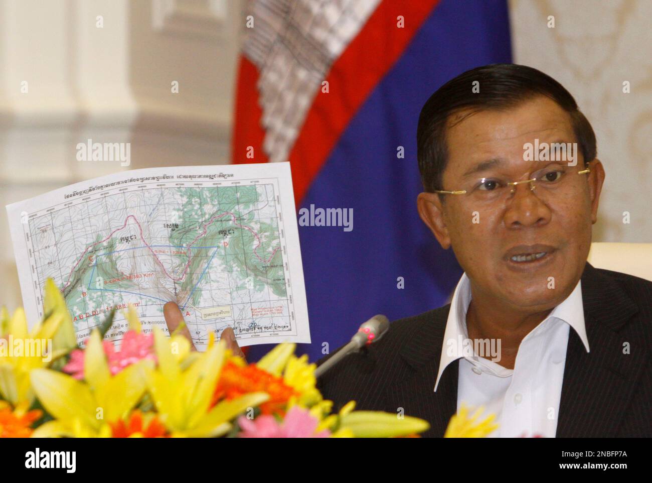 Cambodia's Prime Minister Hun Sen shows a map during a press conference ...