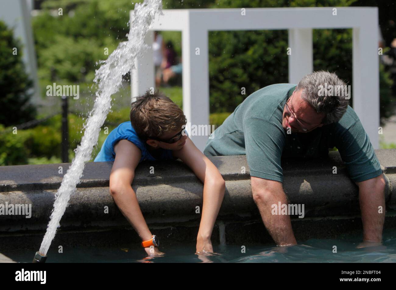 German tourists Michael Pickel, right, and his son Matthias, 12, cool ...
