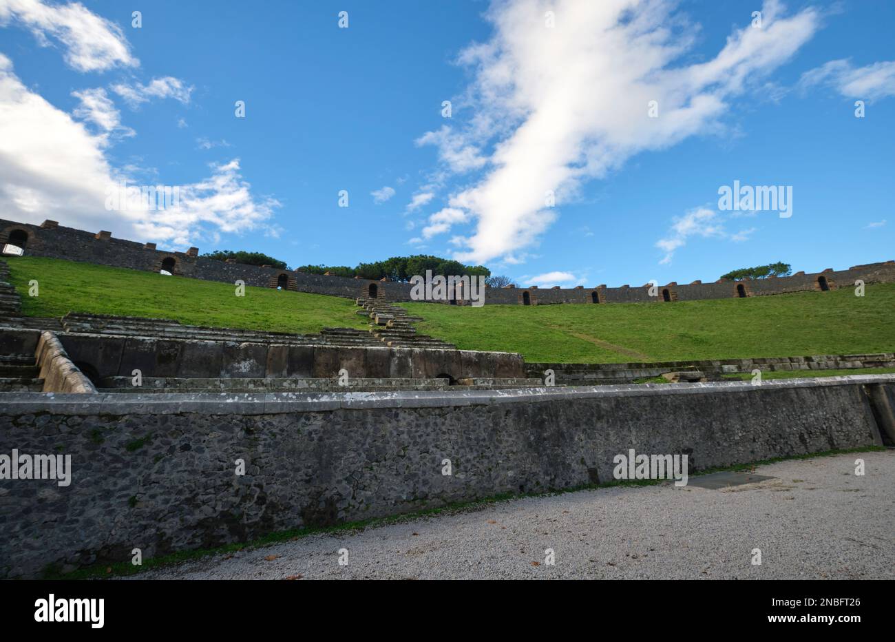 A view of the stone, grass covered amphitheater on a moody day. At ...