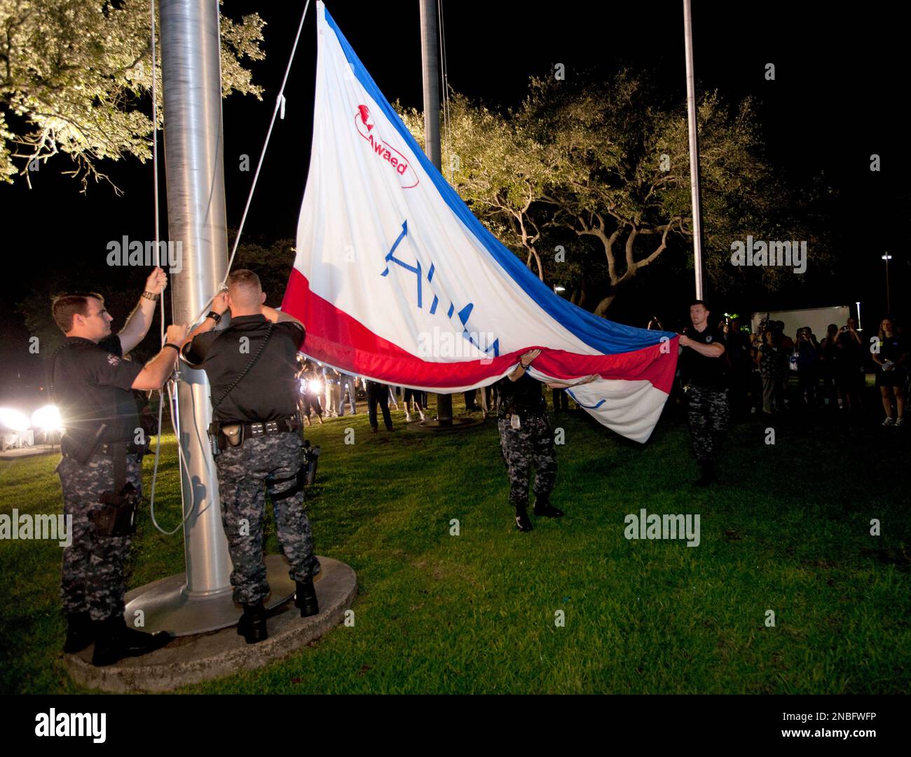 Johnson Space Center security officers lower the space shuttle Atlantis ...