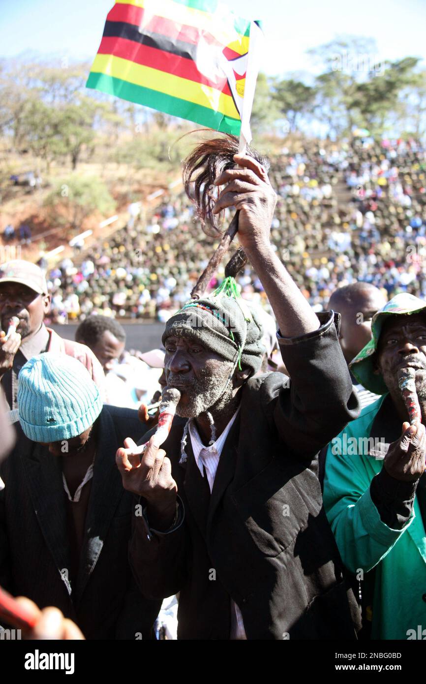 Tonga people blow their traditional chinyela horns at the burial of a ...