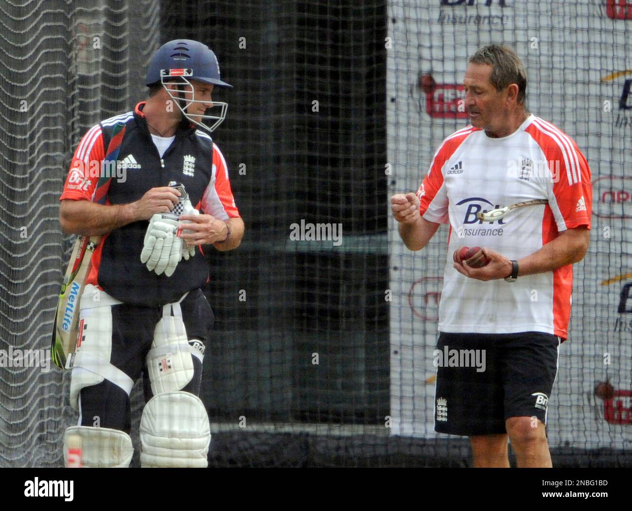 England's Andrew Strauss, left, speaks to batting coach Graham Gooch ...