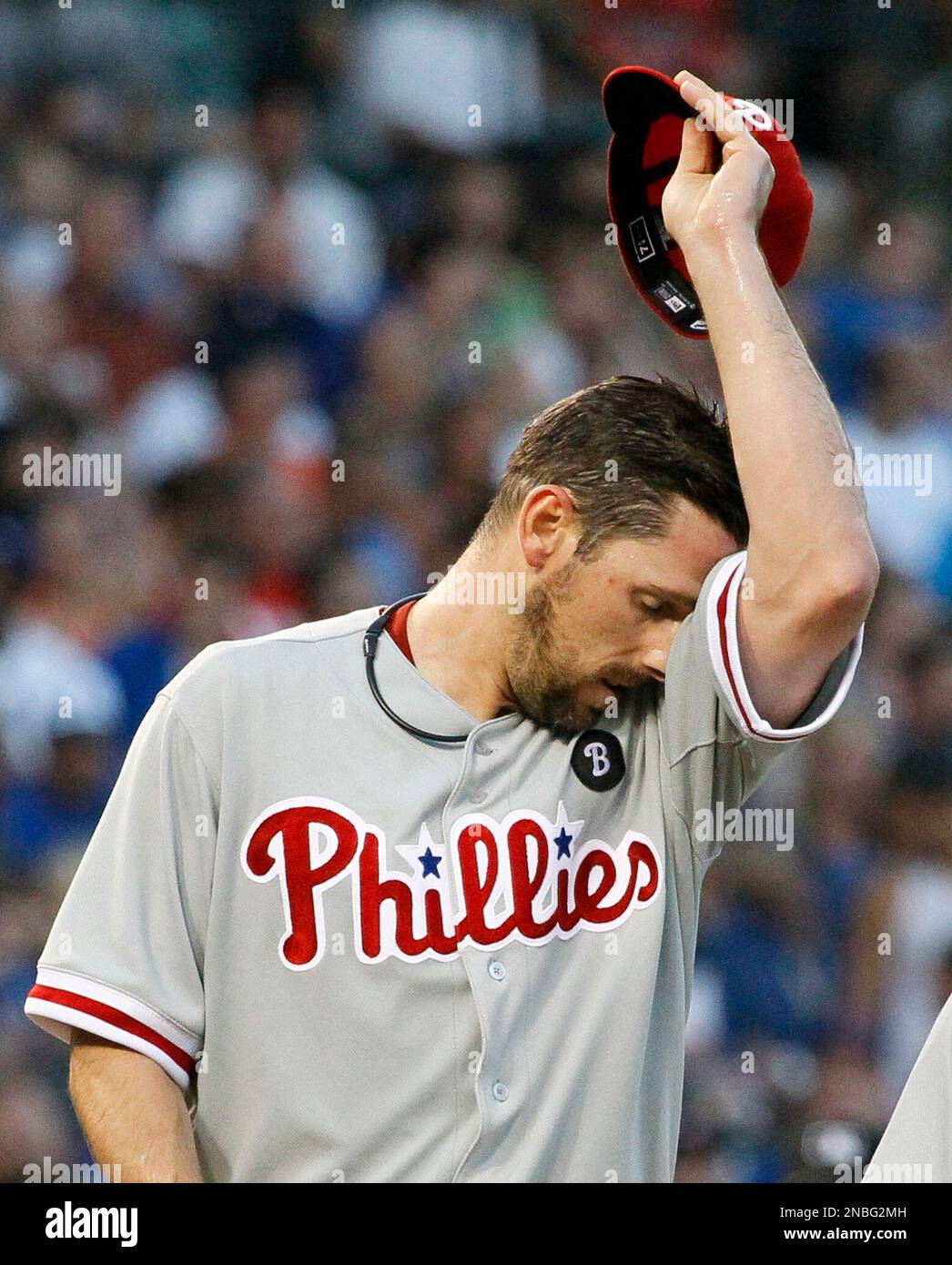 Philadelphia Phillies starting pitcher Cliff Lee wipes the sweat from ...
