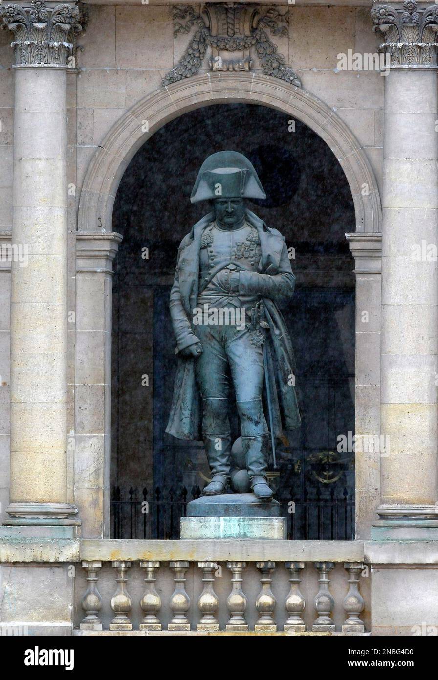 A statue of Napoleon under the rain in the Invalides courtyard in Paris ...