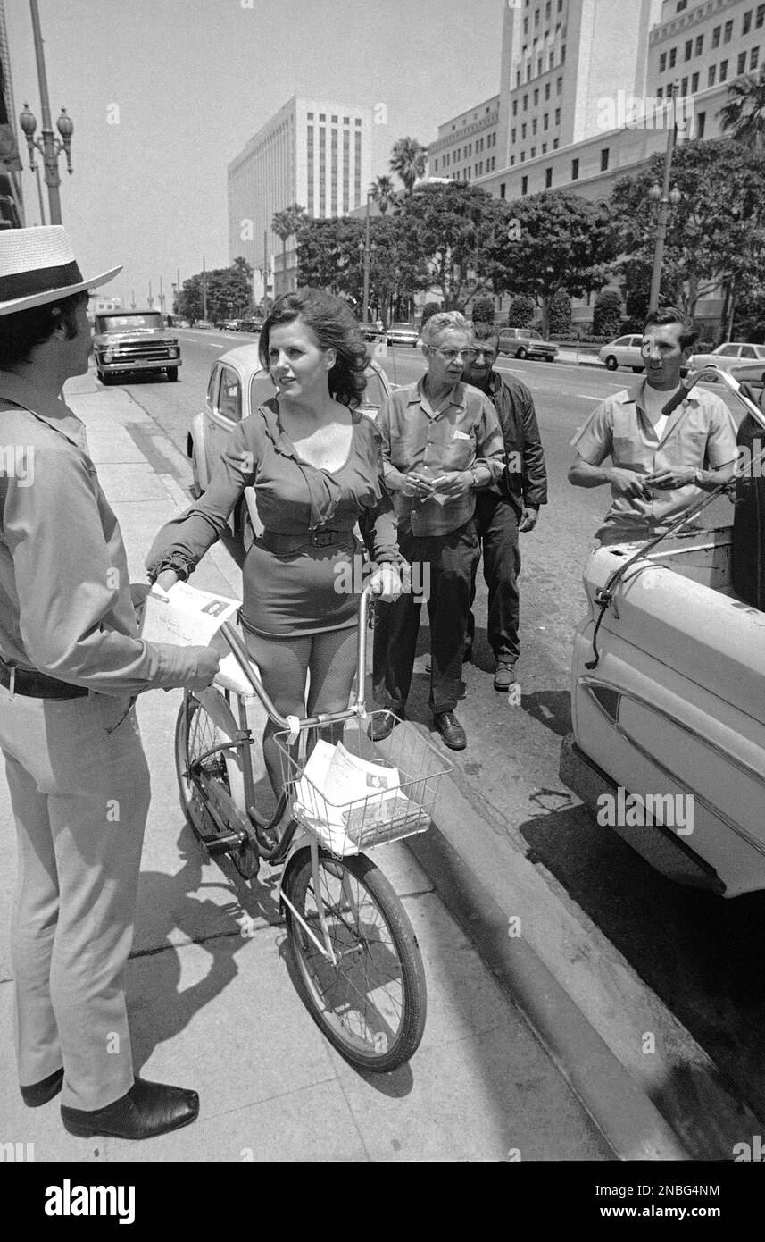 Eileen Anderson, a 32-year-old housewife, uses a miniskirt and bicycle ...