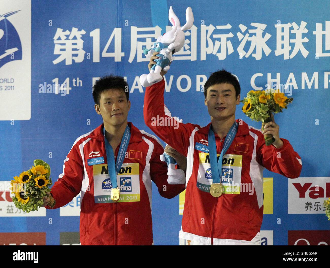 China's Qin Kai, right, and Luo Yutong show the gold medals they won in ...